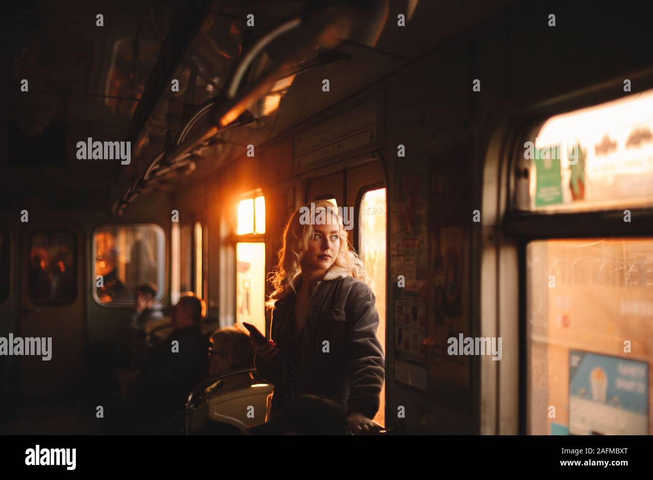 Young woman looking through window traveling in subway train Stock ...