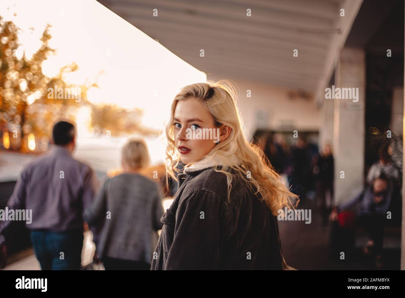 Teenage girl looking back at camera walking on subway station Stock ...