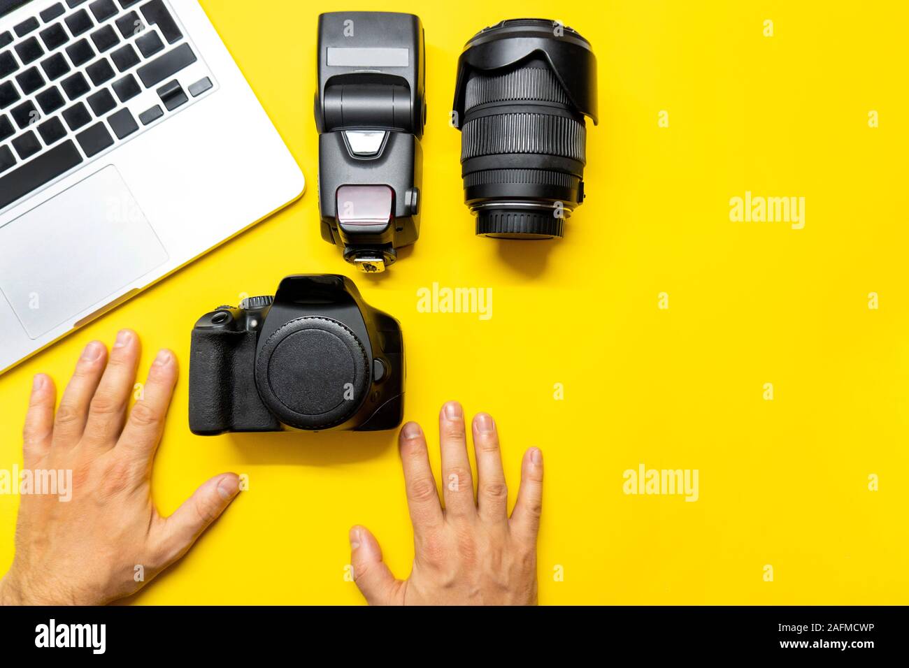 Photocamera, laptop, flashlight, lens on yellow background Stock Photo ...
