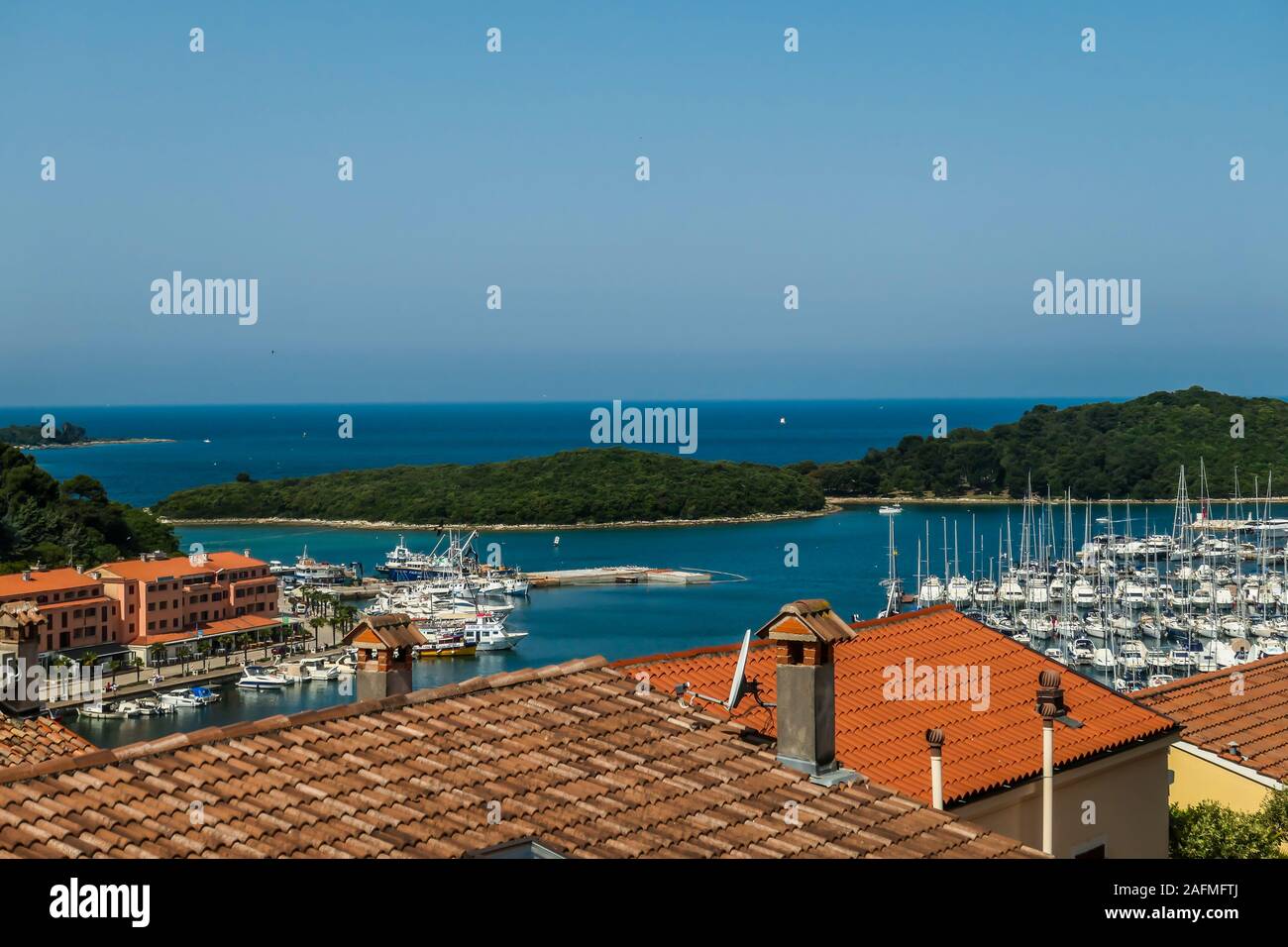 A remote view on the harbour from a hill. Rows of docks waiting for the ...