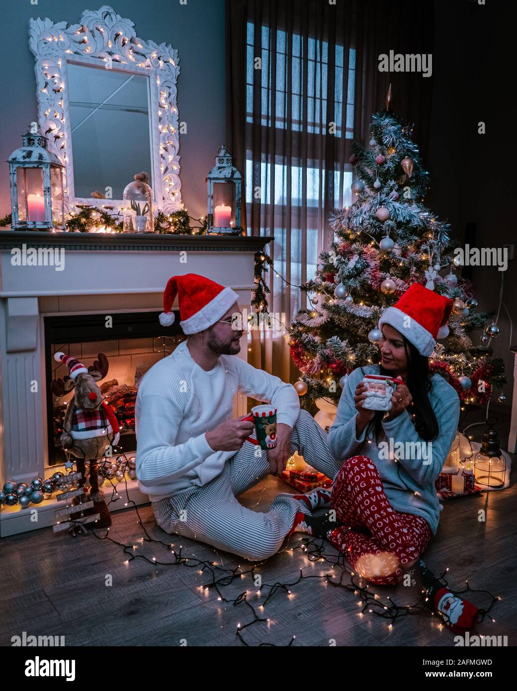 cute couple christmas tree, couple drinking hot chocolate under ...