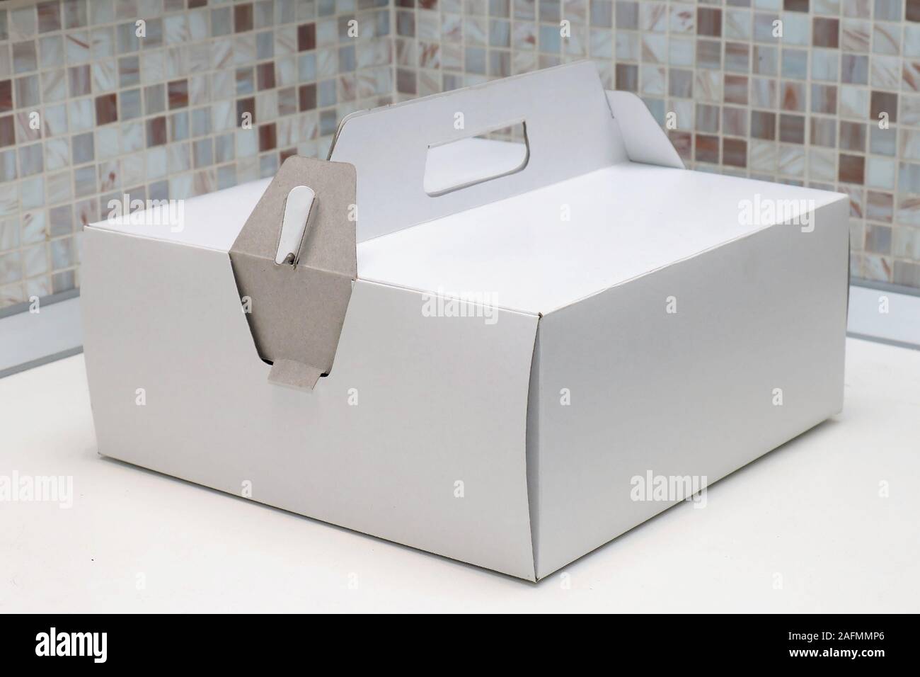 Closed white cardboard cake box inside on kitchen table Stock Photo - Alamy