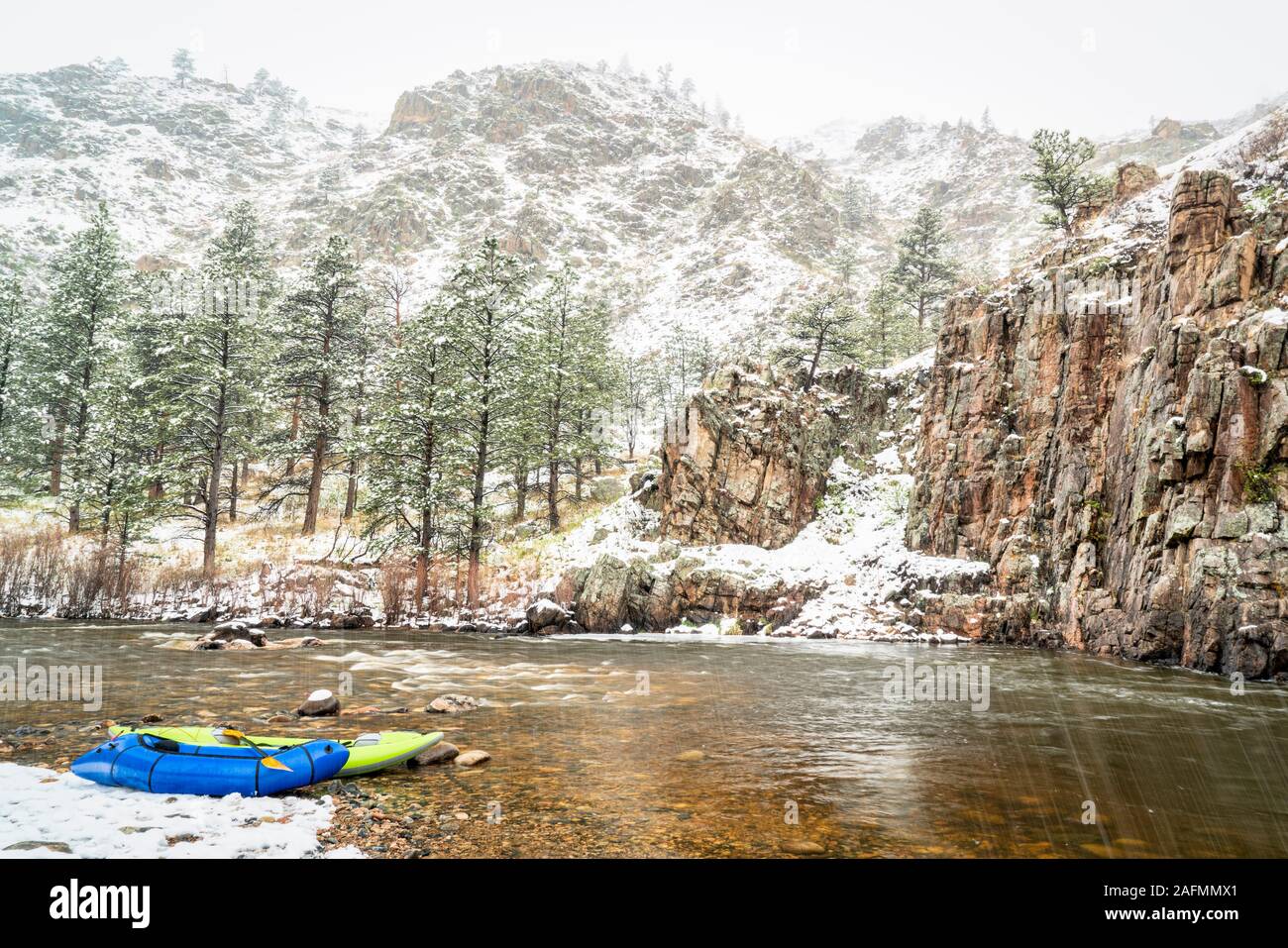 inflatable whitewater kayak and packraft on a shore of mountain river ...