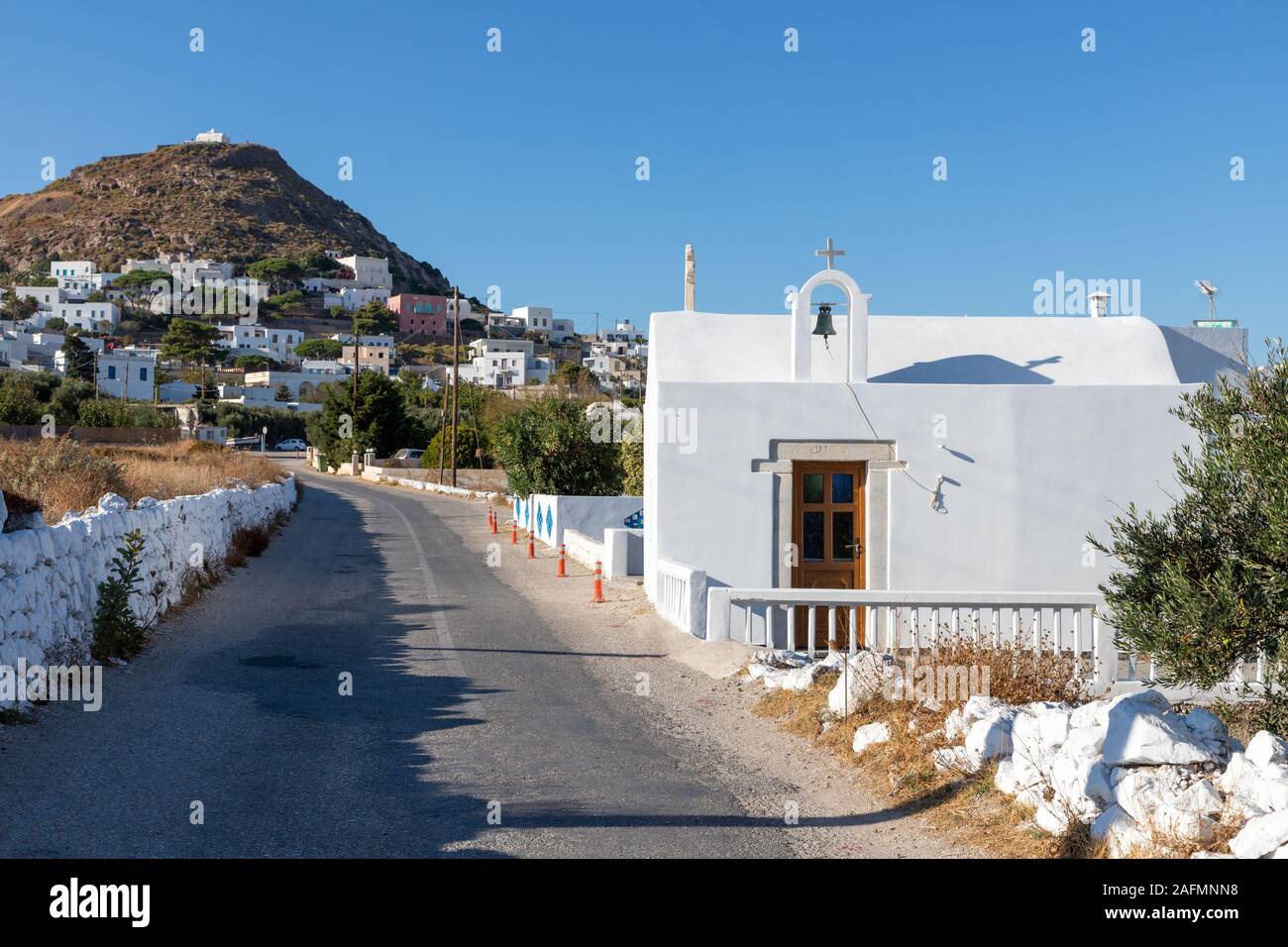 Small church with Plaka village in background, Milos, Greece Stock ...