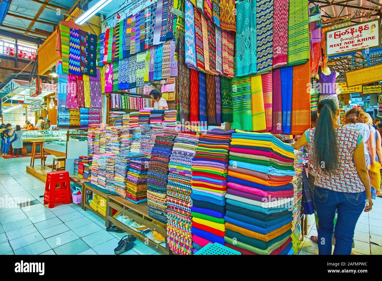 YANGON, MYANMAR - FEBRUARY 17, 2018: The stall with different textiles ...