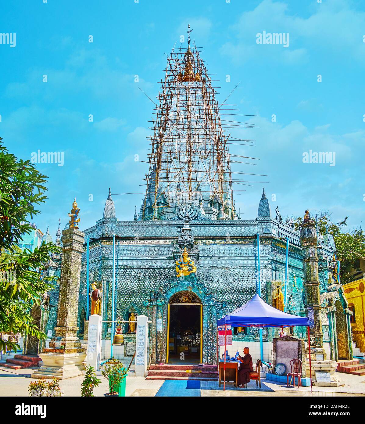 YANGON, MYANMAR - FEBRUARY 17, 2018: The stunning facade of mirrored Sein Yaung Chi Pagoda ...