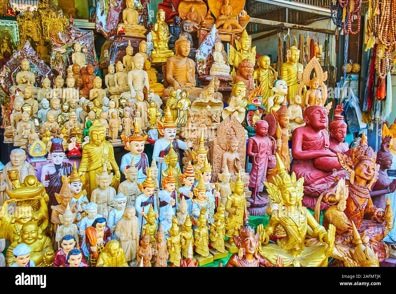 The showcase of traditional market stall with large amount of Buddhist ...