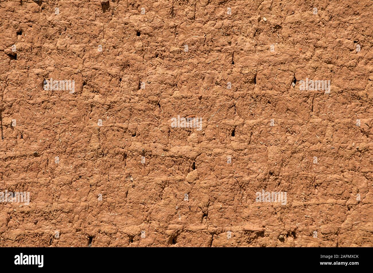 Adobe clay weathered wall of rural vintage country house closeup as ...
