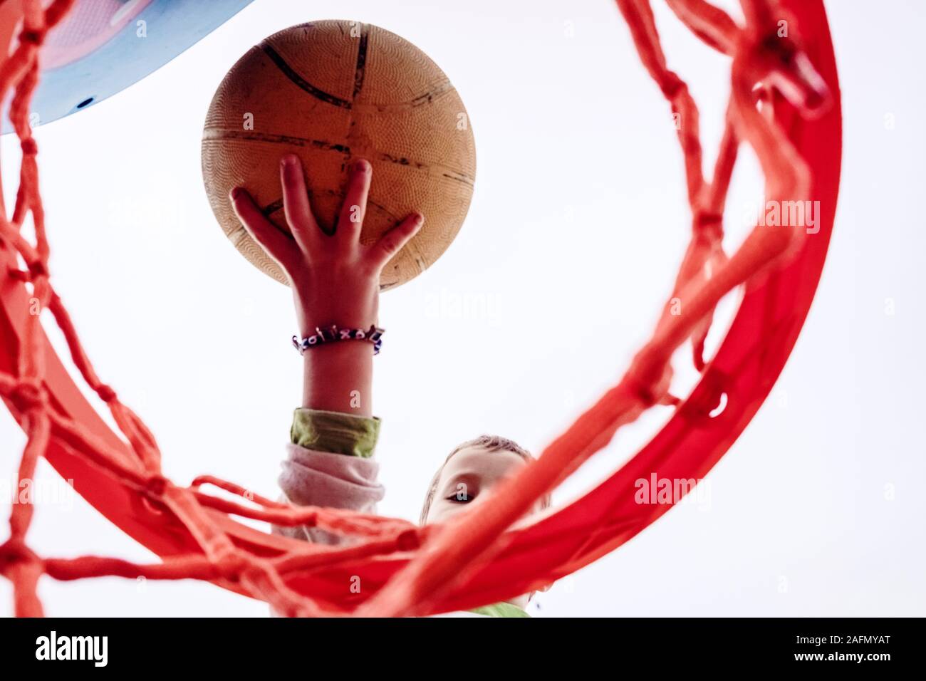 Boy hitting a basketball, seen from below Stock Photo - Alamy