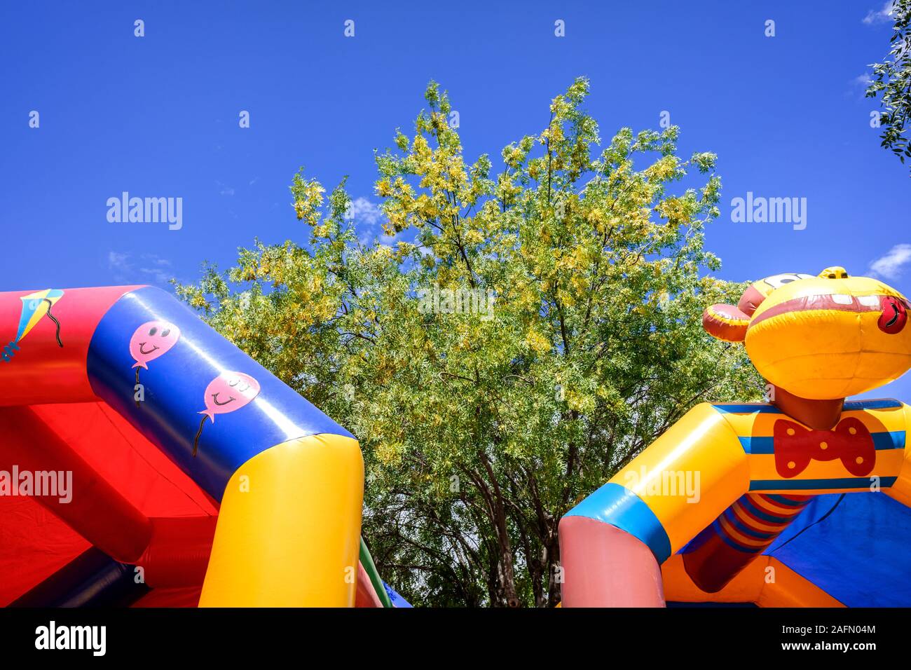 Colorful inflatable castles for children to jump and bounce in an ...