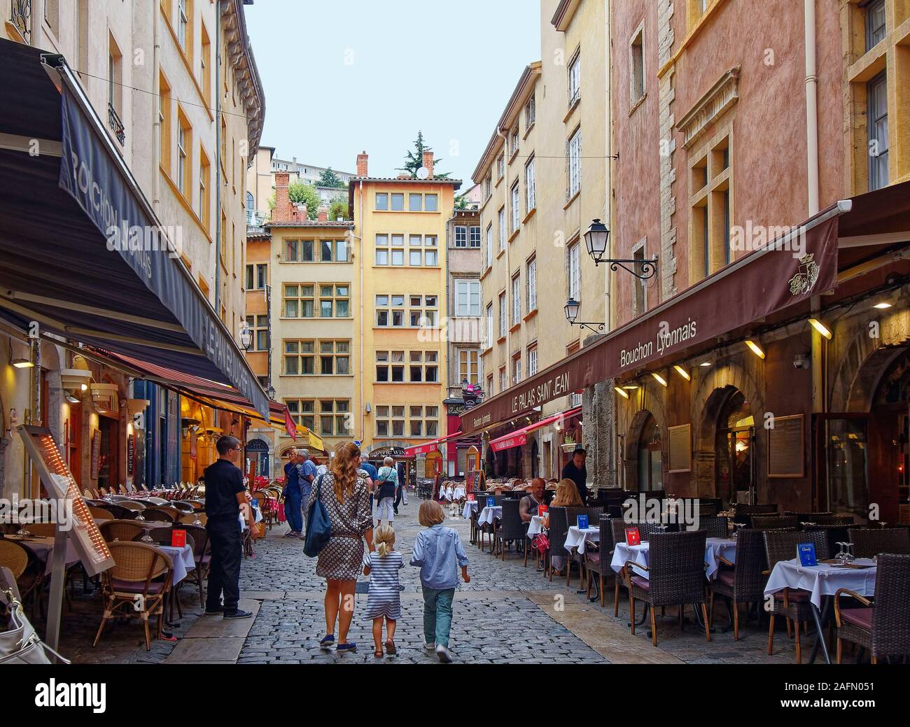 pedestrian street scene, cobblestone, restaurants, outdoor tables ...