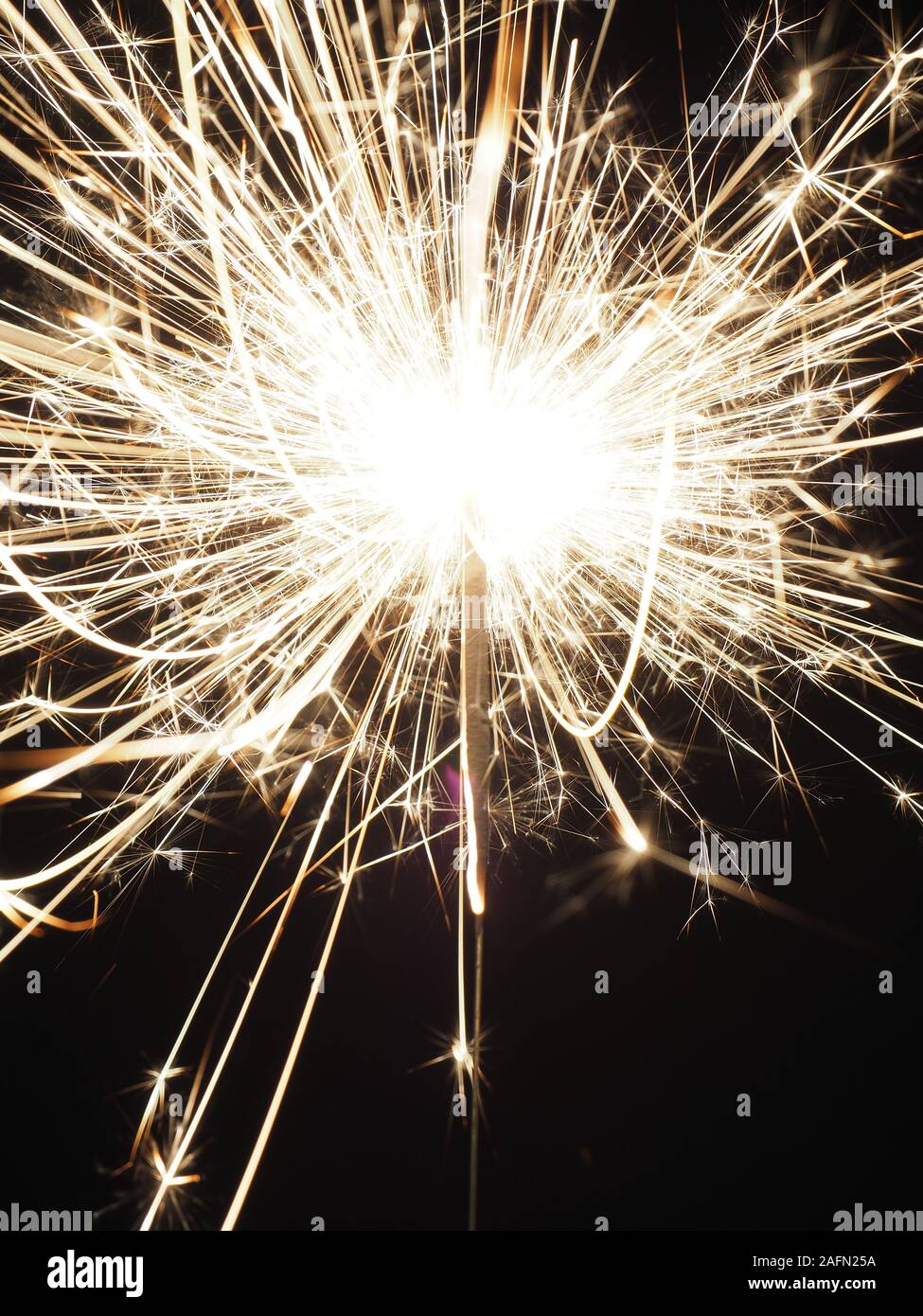 Bright sparkler on a dark background, New Years or birthday concept ...