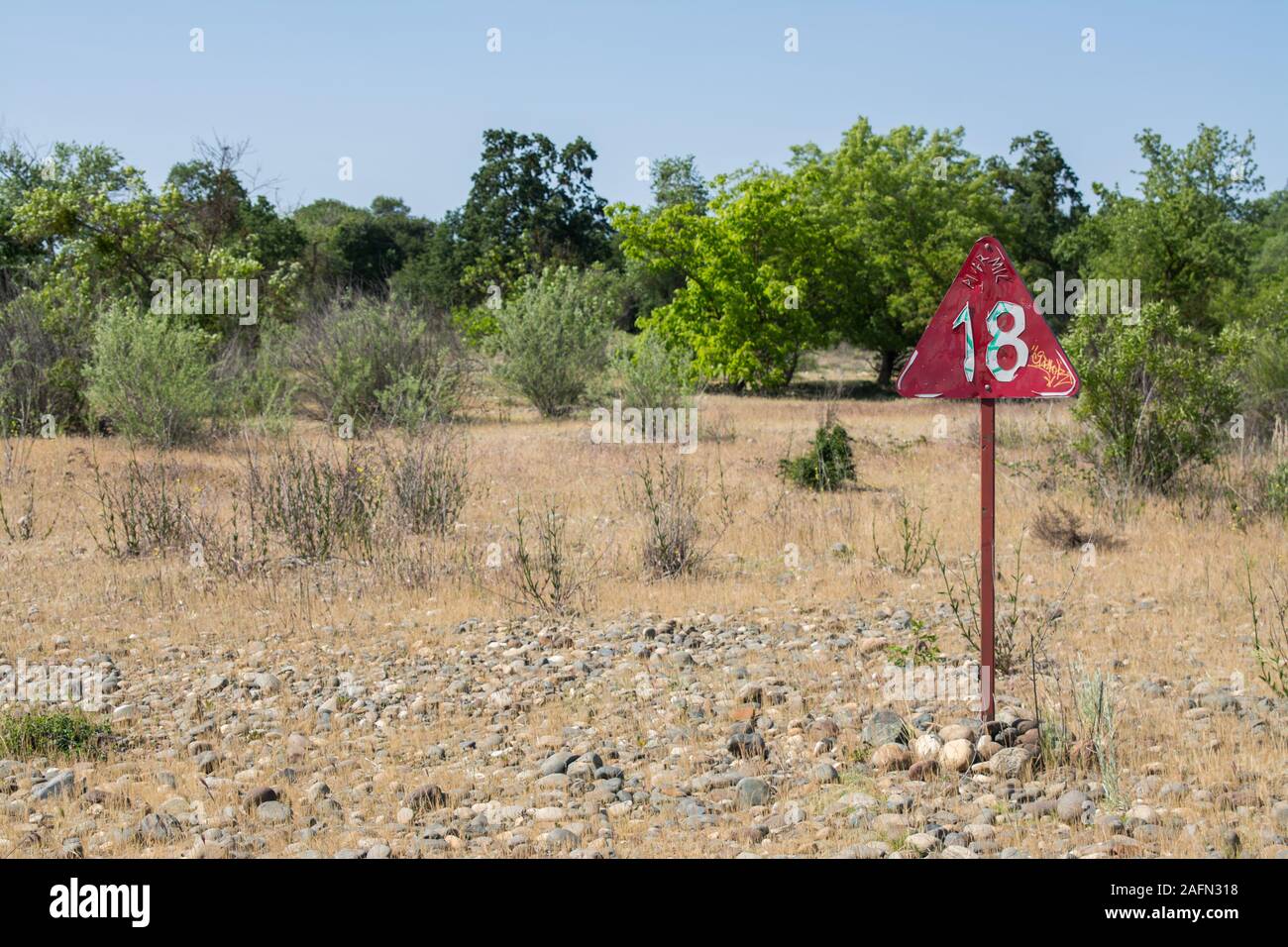Old abandoned traffic sign along shoreline Stock Photo - Alamy
