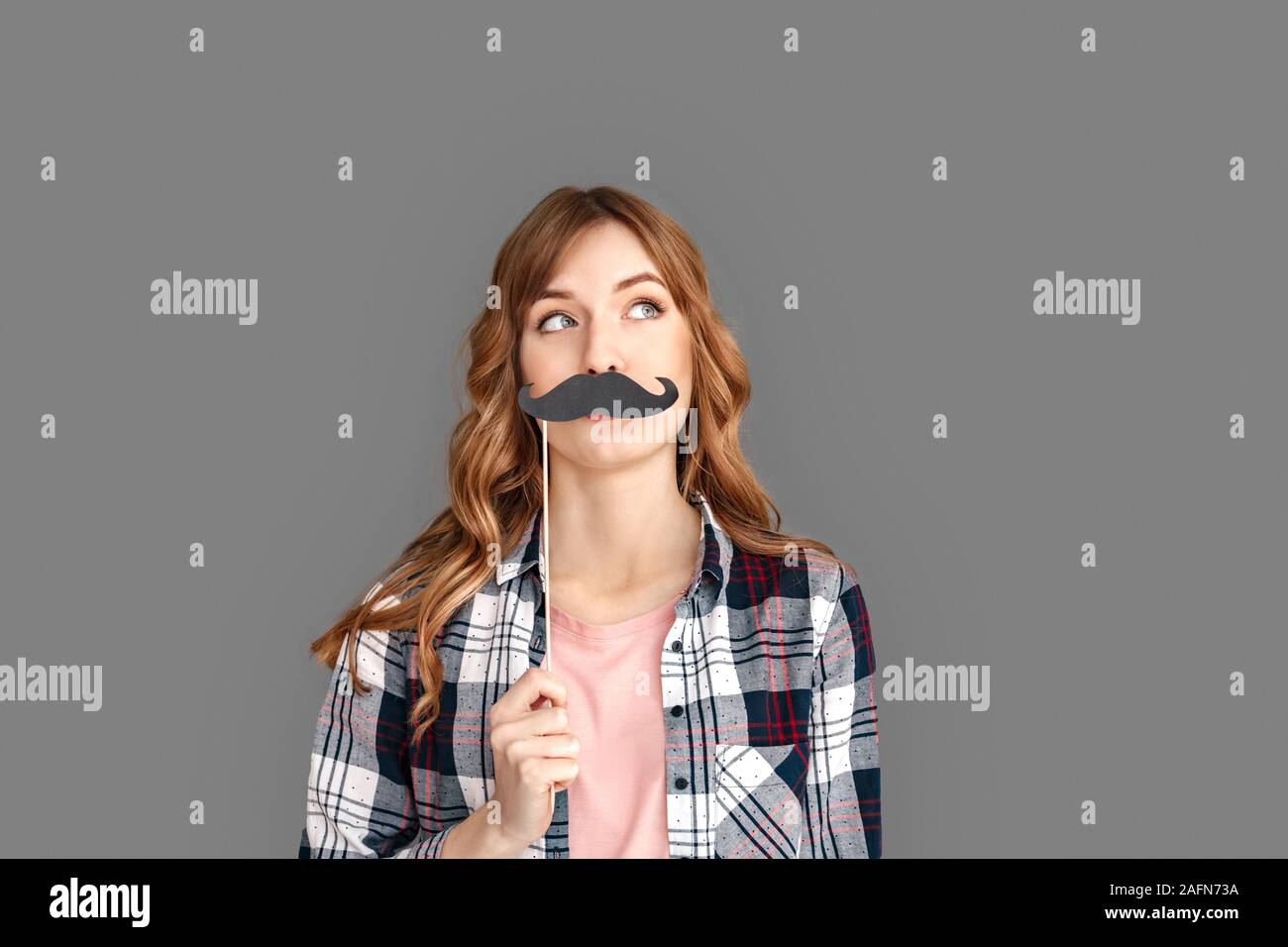 Freestyle. Stylish woman studio standing isolated on grey posing with ...