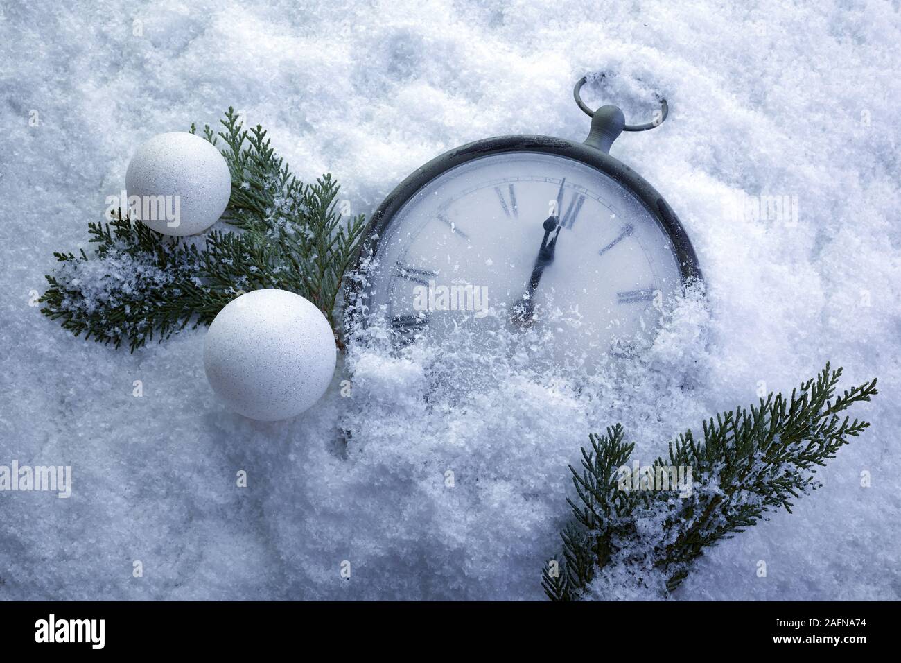 Christmas Time Clock under snow, countdown to midnight Stock Photo - Alamy