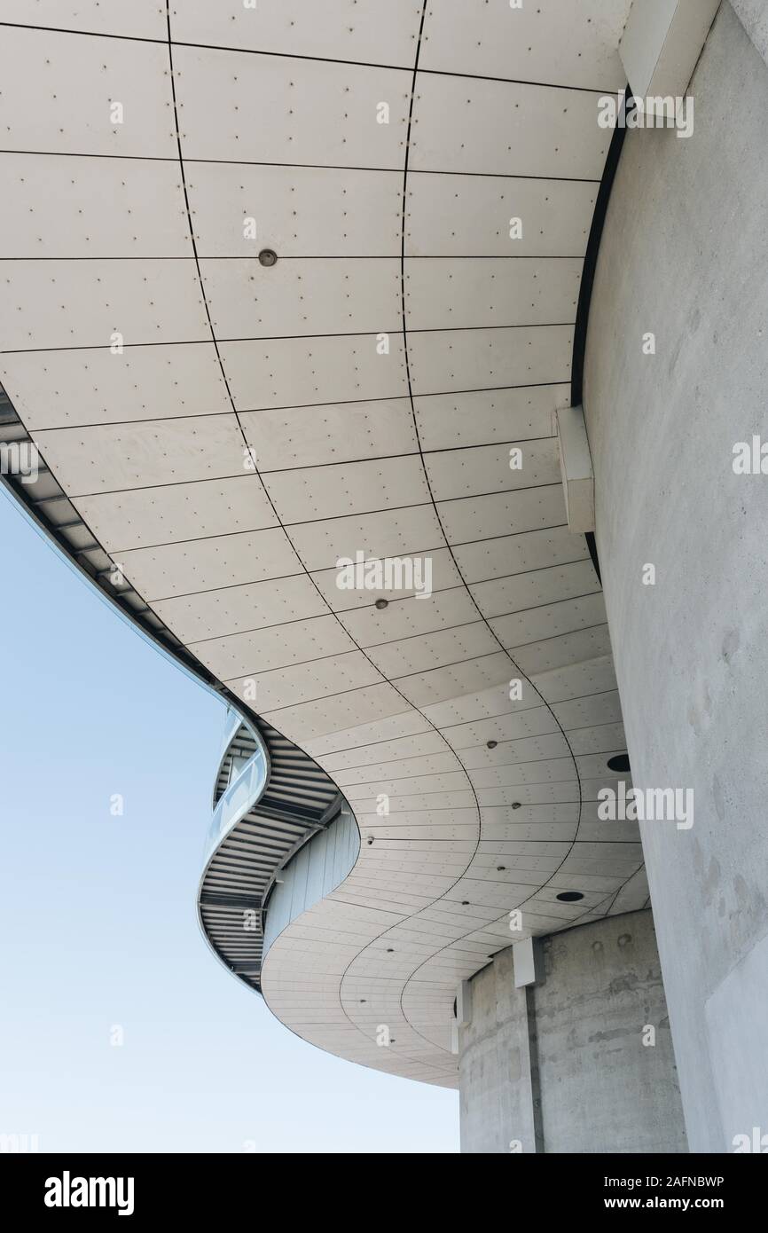 Vertical low angle shot of white concrete building under the blue sky Stock Photo - Alamy