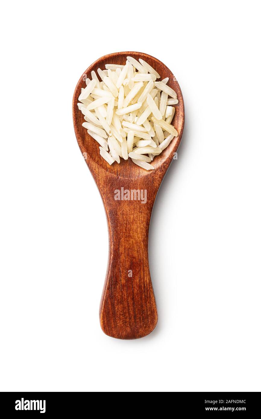 Uncooked indian long rice in wooden scoop isolated on white background ...