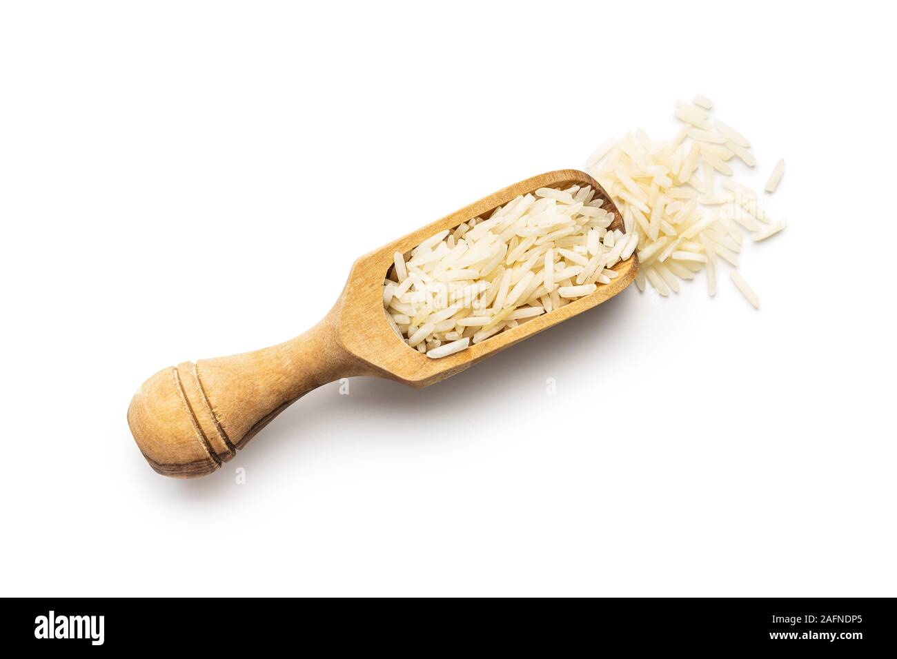 Uncooked indian long rice in wooden scoop isolated on white background ...