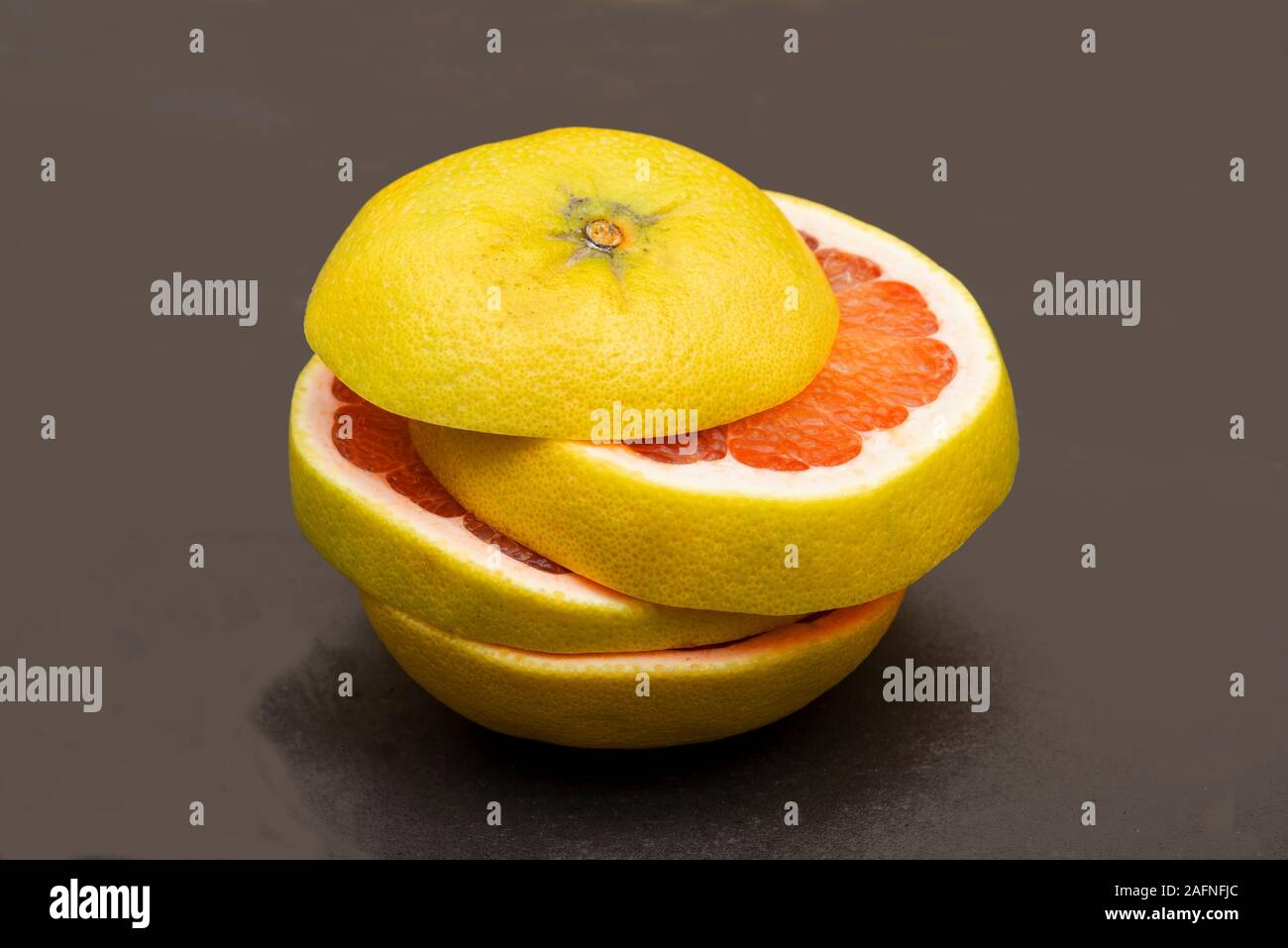 Close up photo of grapefruit on gray background Stock Photo - Alamy