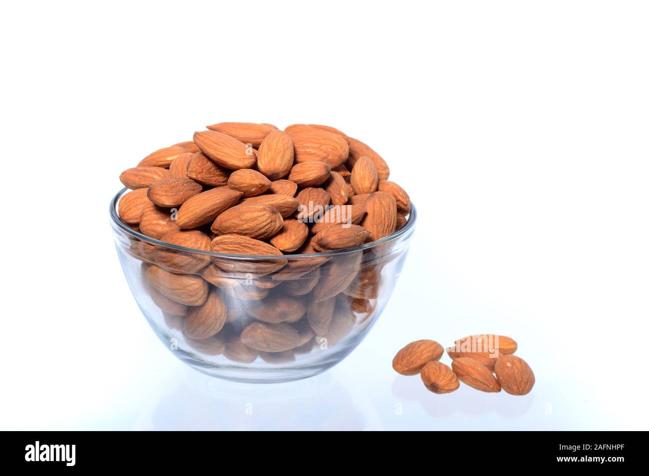 Almonds in a bowl isolated on a white background Stock Photo - Alamy