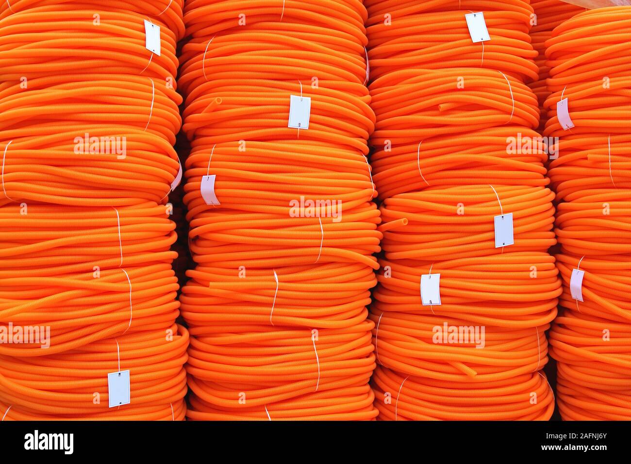Big Pile of Orange Plastic Cables in Coils Stock Photo - Alamy
