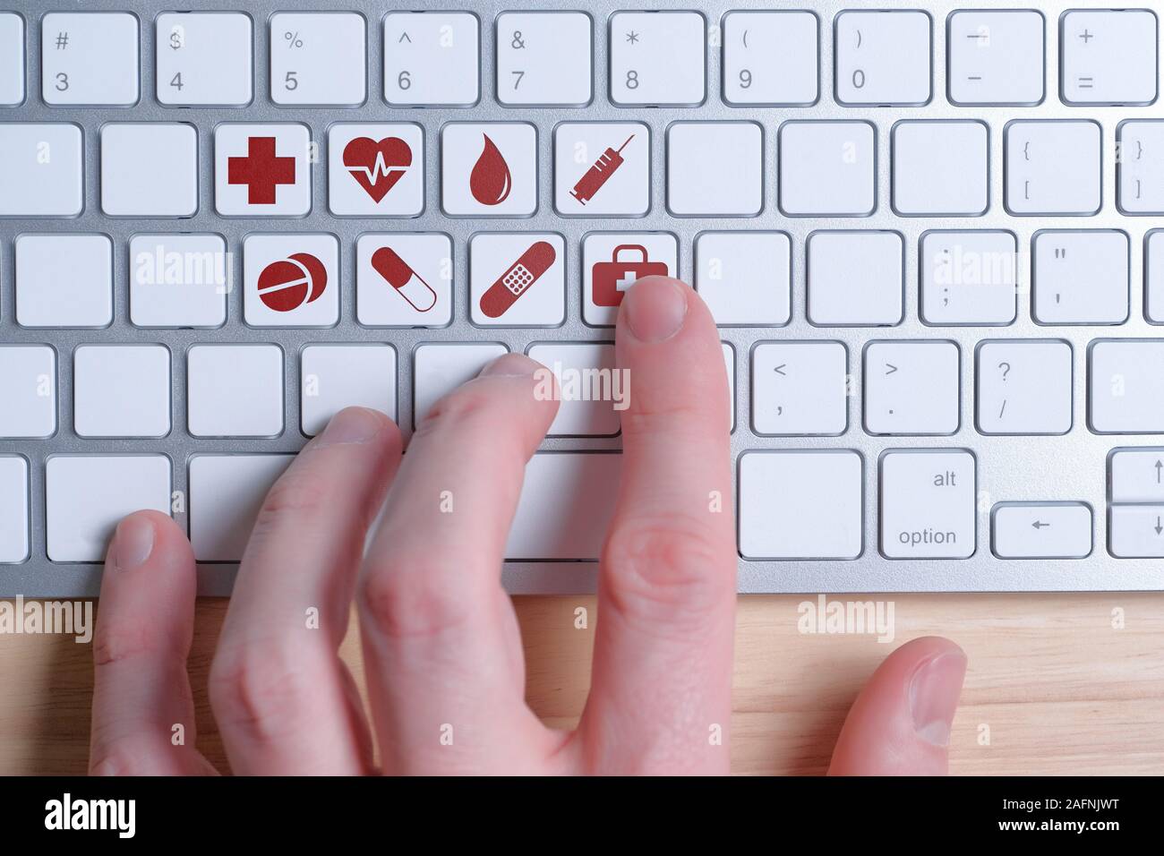 Choosing the necessary medical care online. Hand on the keyboard with ...