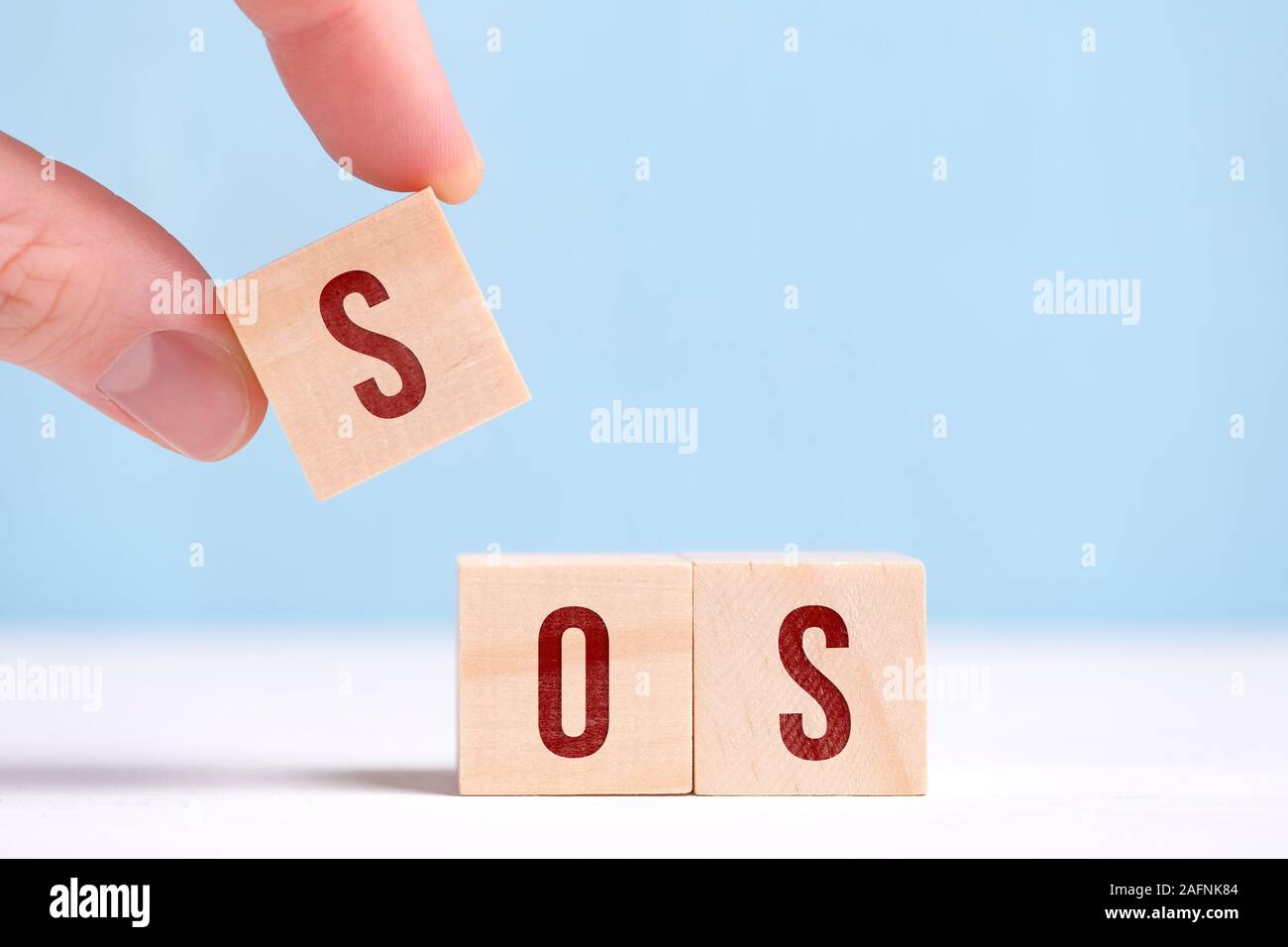 The concept of calling for the doctor's help - sos. Fingers hold a cube ...