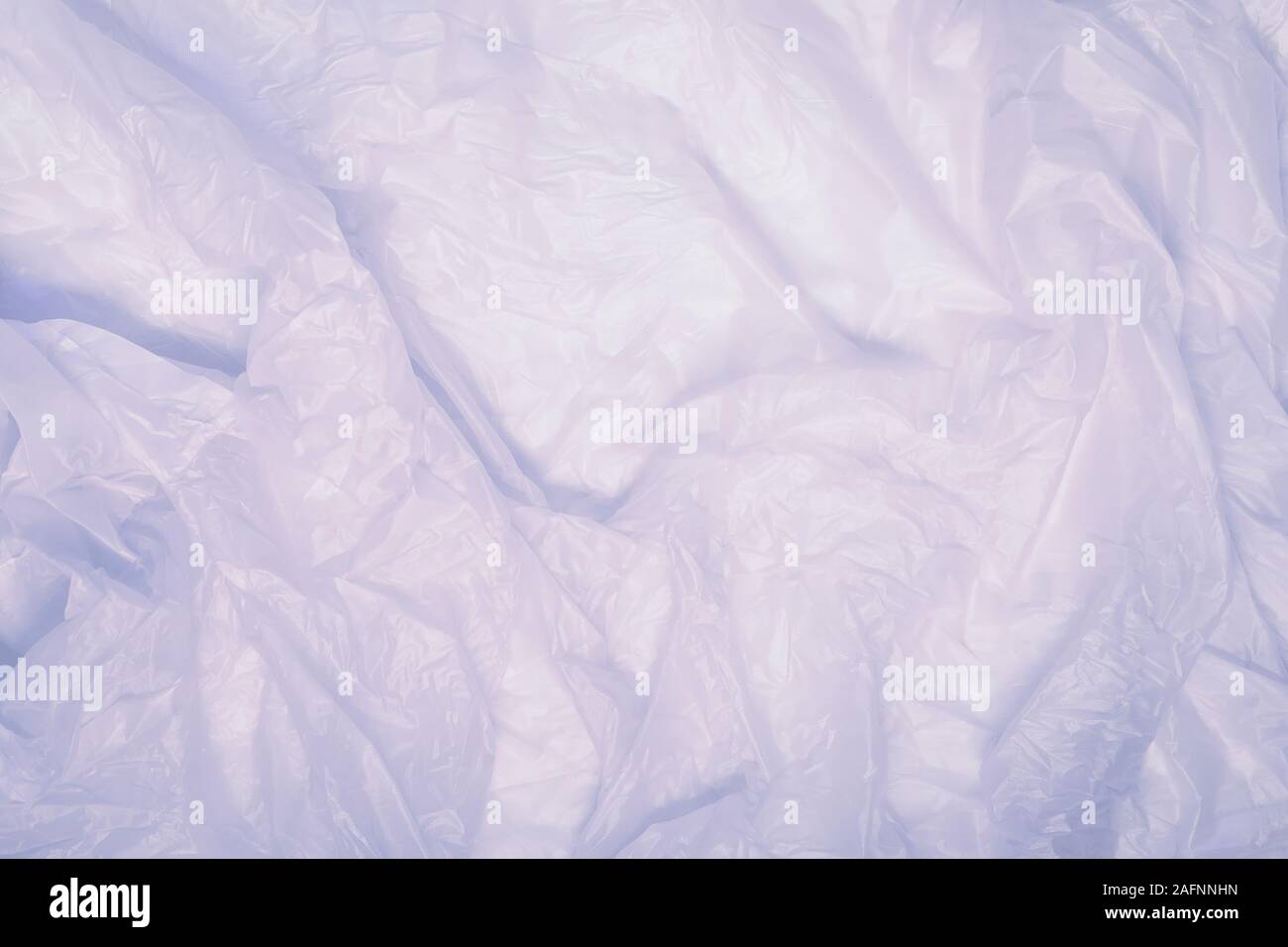 Abstract texture of light crumpled transparent cellophane, polyethylene ...
