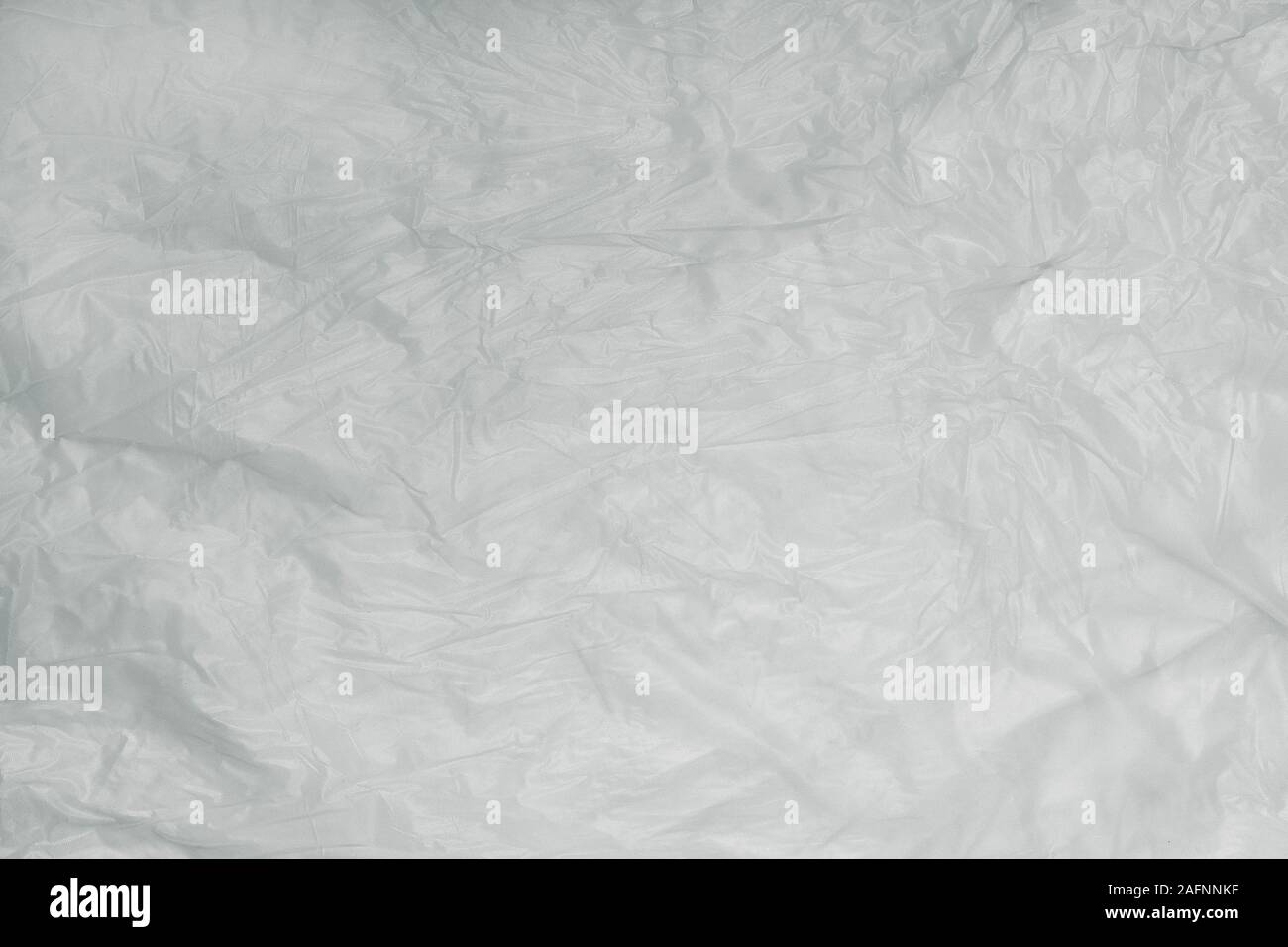 Abstract texture of light crumpled polyethylene, plastic for recycling ...