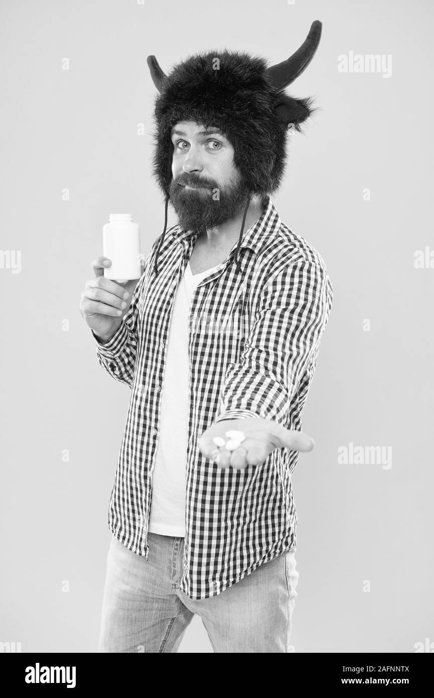 Treat pain, fever and inflammation. Bearded man hold pill bottle. Sick ...