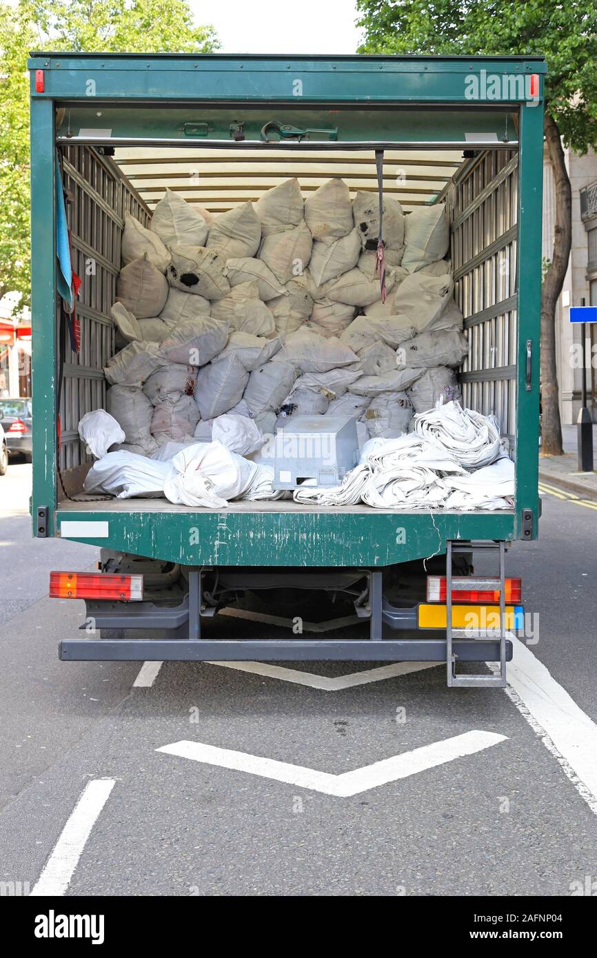 Big delivery truck collecting dirty laundry bags Stock Photo - Alamy
