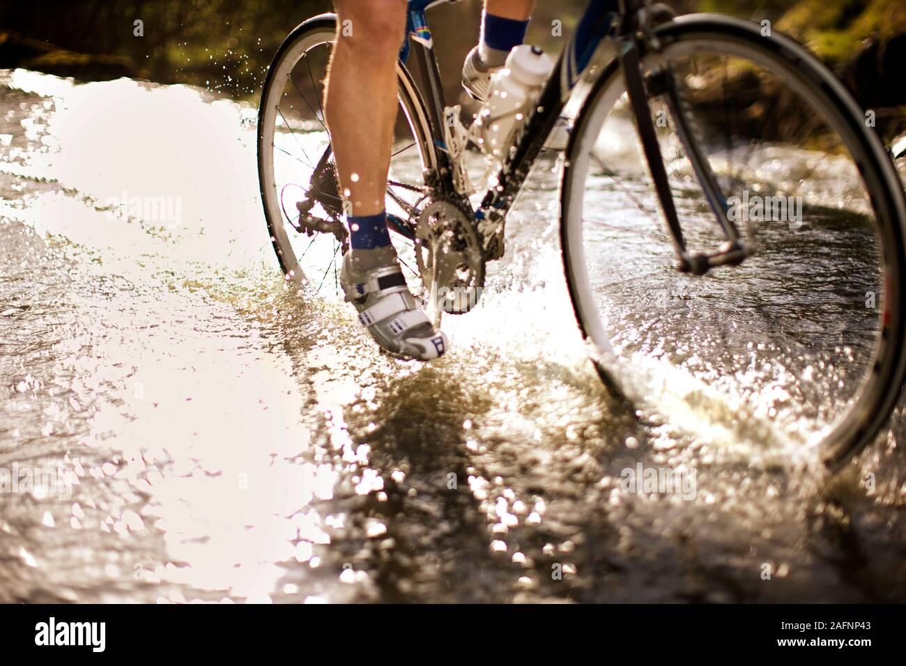 Riding a bike through a puddle hi-res stock photography and images - Alamy