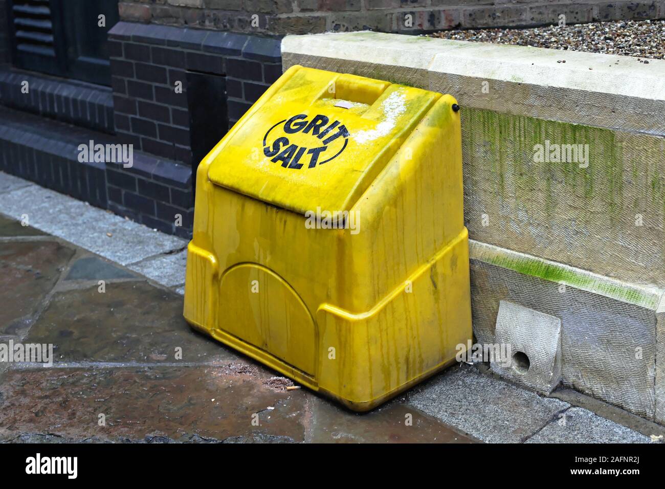 Grit salt yellow plastic box on street pavement Stock Photo - Alamy
