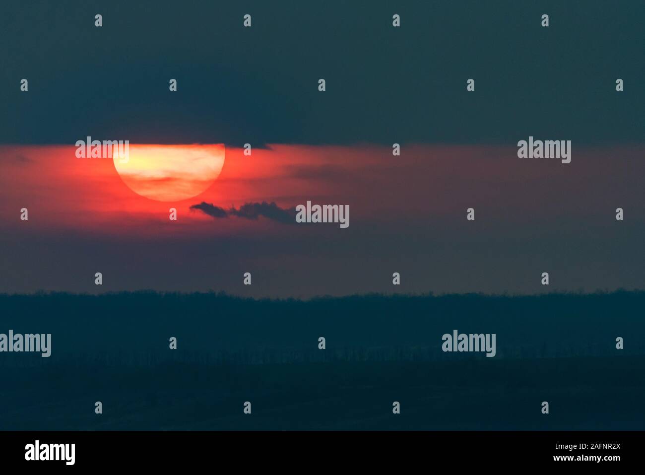 Gorgeous colorful sunset skyscape with black clouds and red setting sun ...