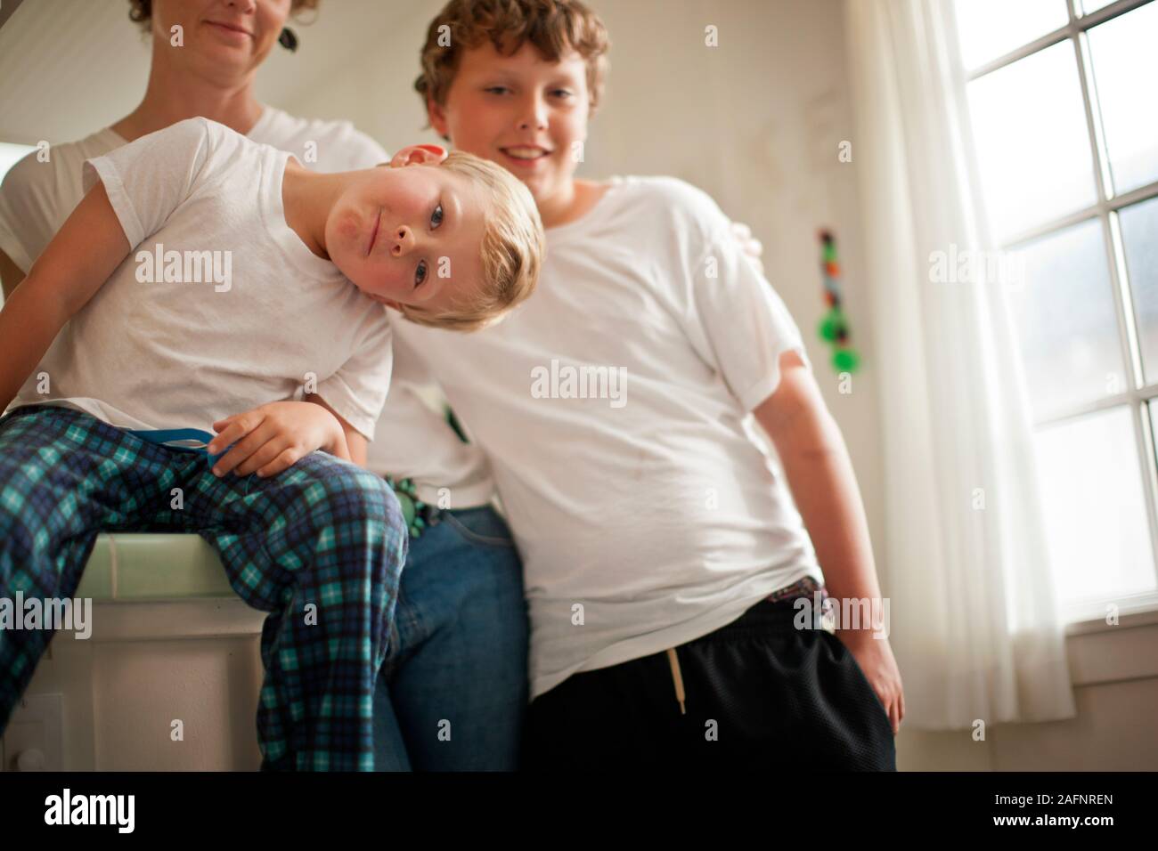 Silly family portrait of a mother and her two sons Stock Photo - Alamy