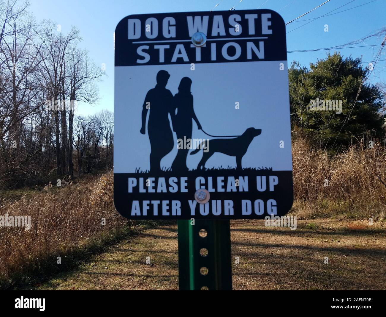 dog waste station sign please clean up after your dog and grass Stock ...