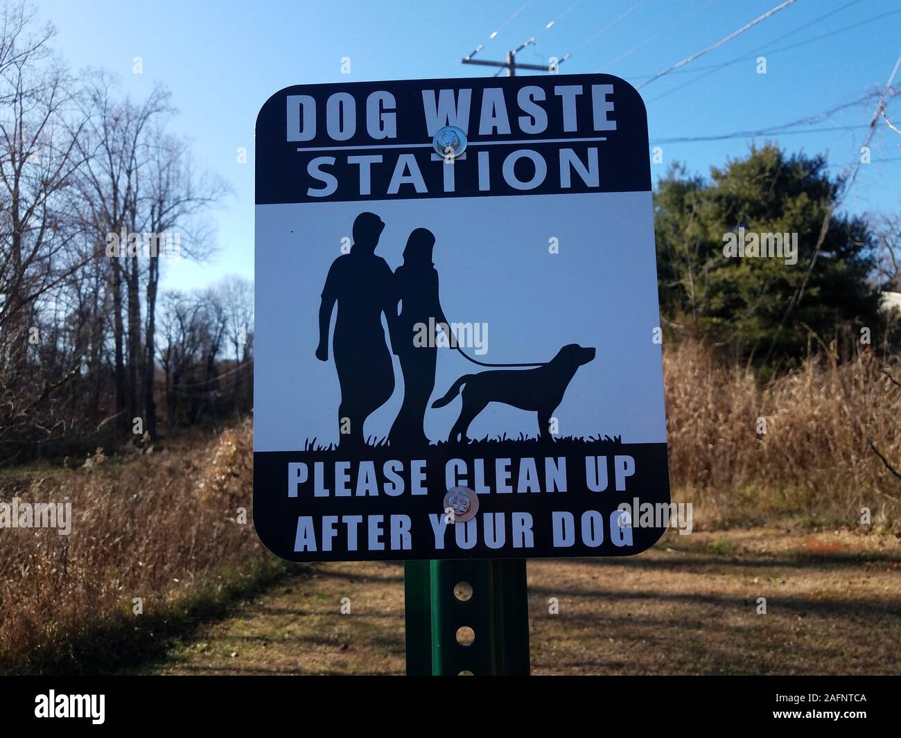 dog waste station sign please clean up after your dog and grass Stock ...