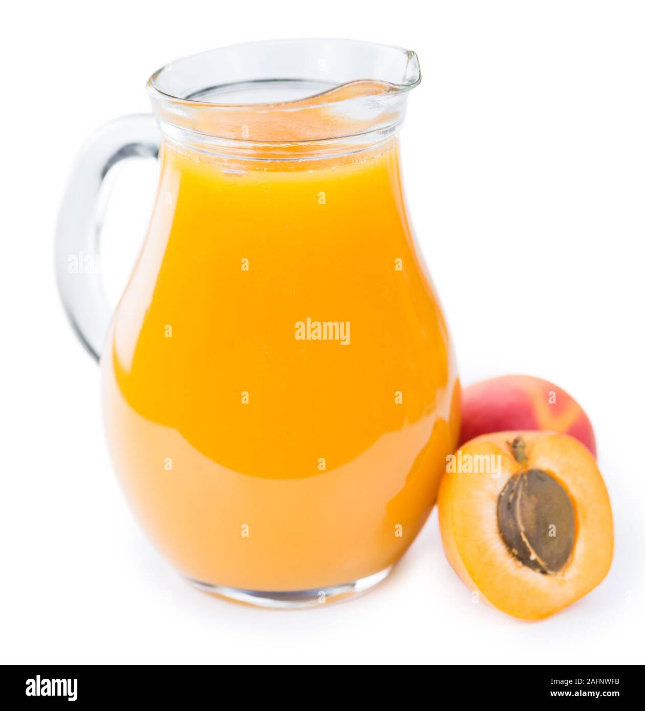 Portion of Apricot Juice (as close-up shot) isolated on white ...