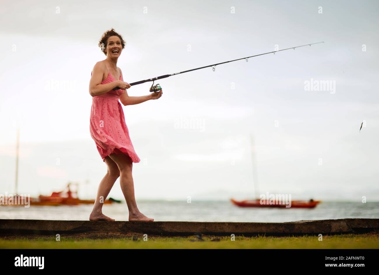 Mature woman having fun fishing Stock Photo - Alamy