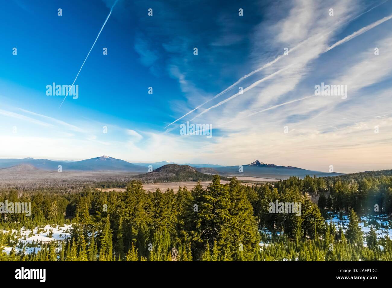 Mount Thielsen and cinder cones stud the landscape, with contrails ...