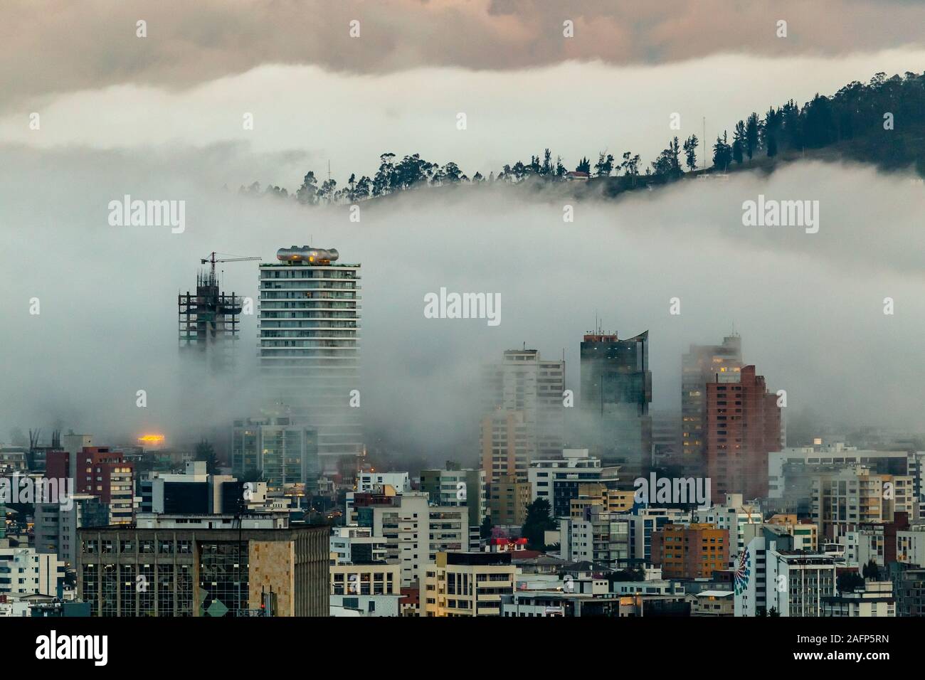 Buildings surrounded by fog at the end of a warm afternoon in the ...
