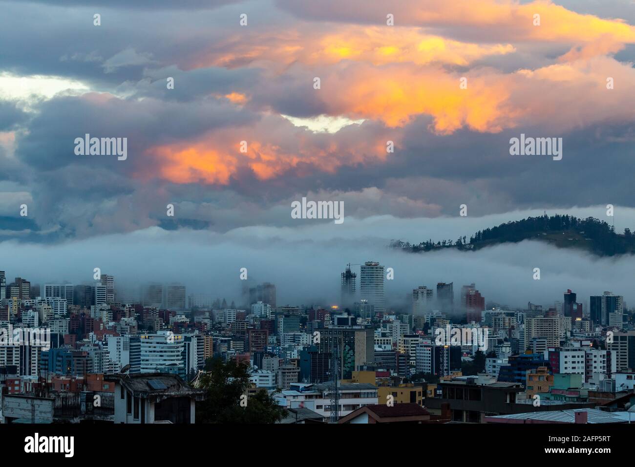 Buildings surrounded by fog at the end of a warm afternoon in the ...
