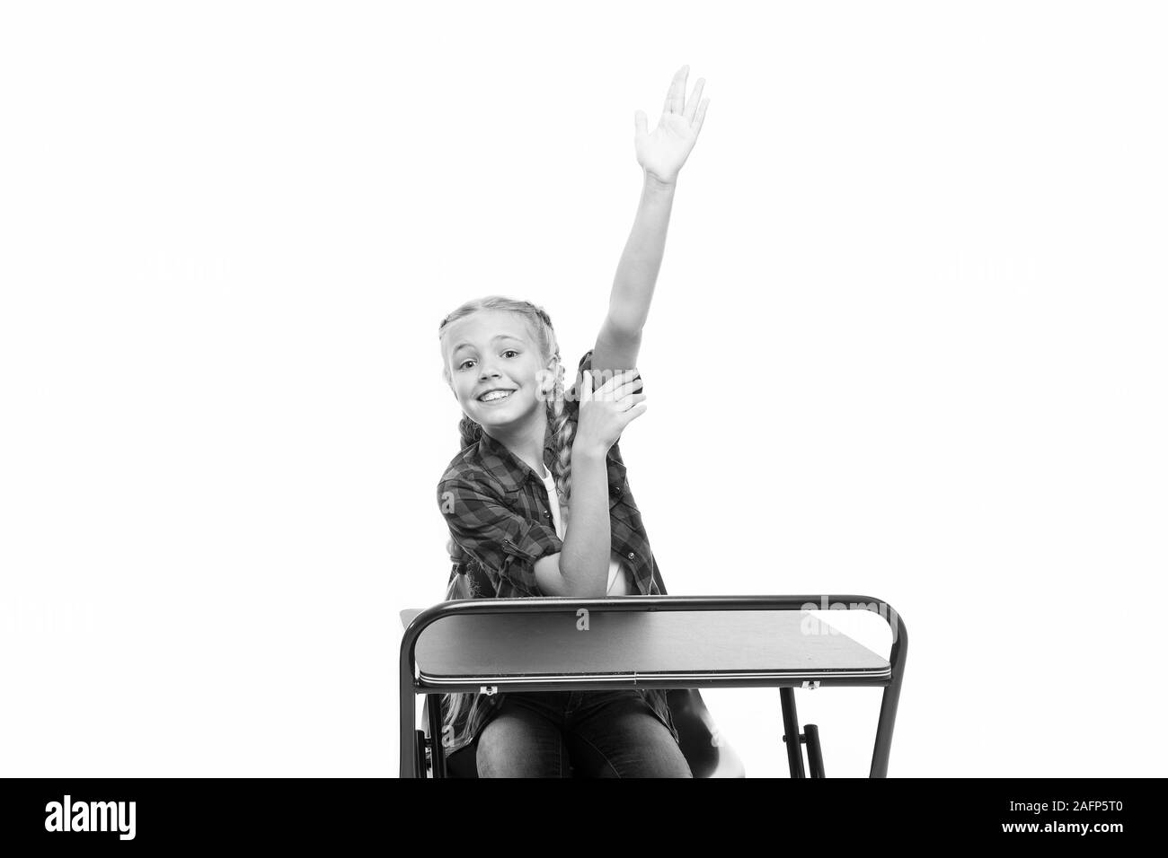 She is up on her homework. Adorable small child raising hand to recite ...