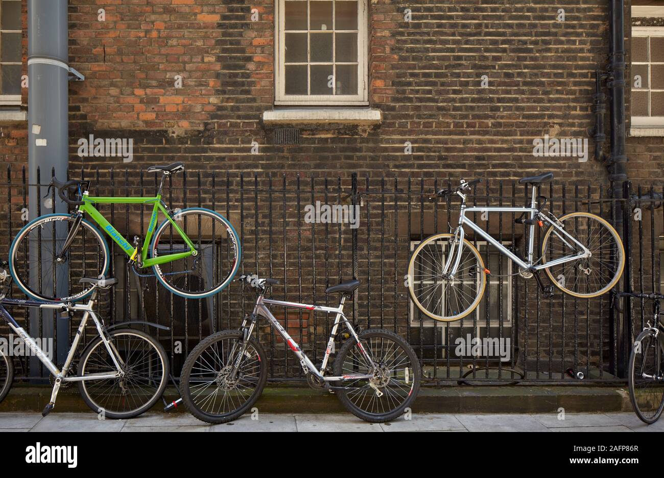 Cycle locked to railing hi-res stock photography and images - Alamy