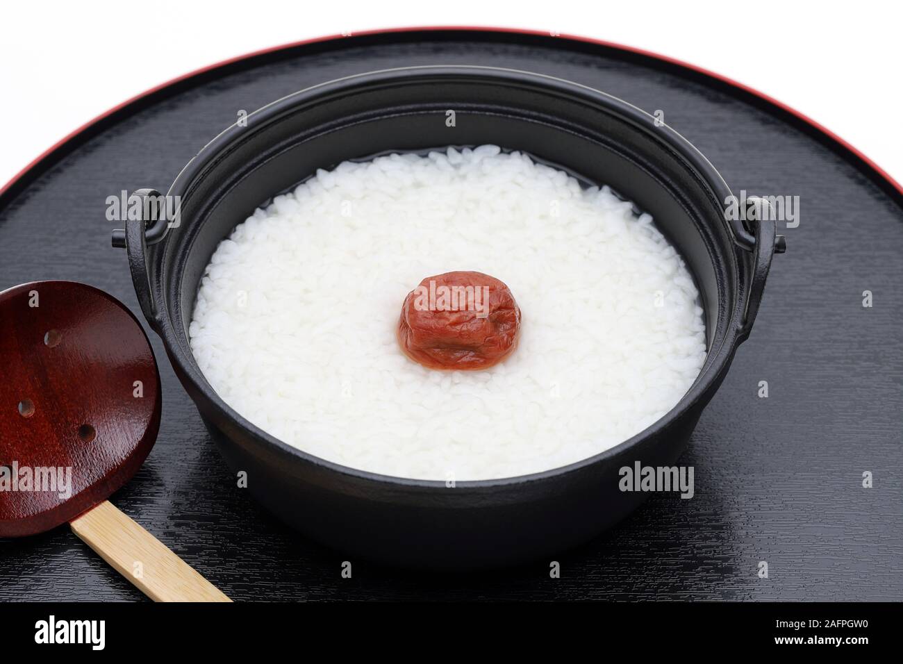 Japanese food, Okayu and Umeboshi in a nade bowl on wooden tray Stock ...