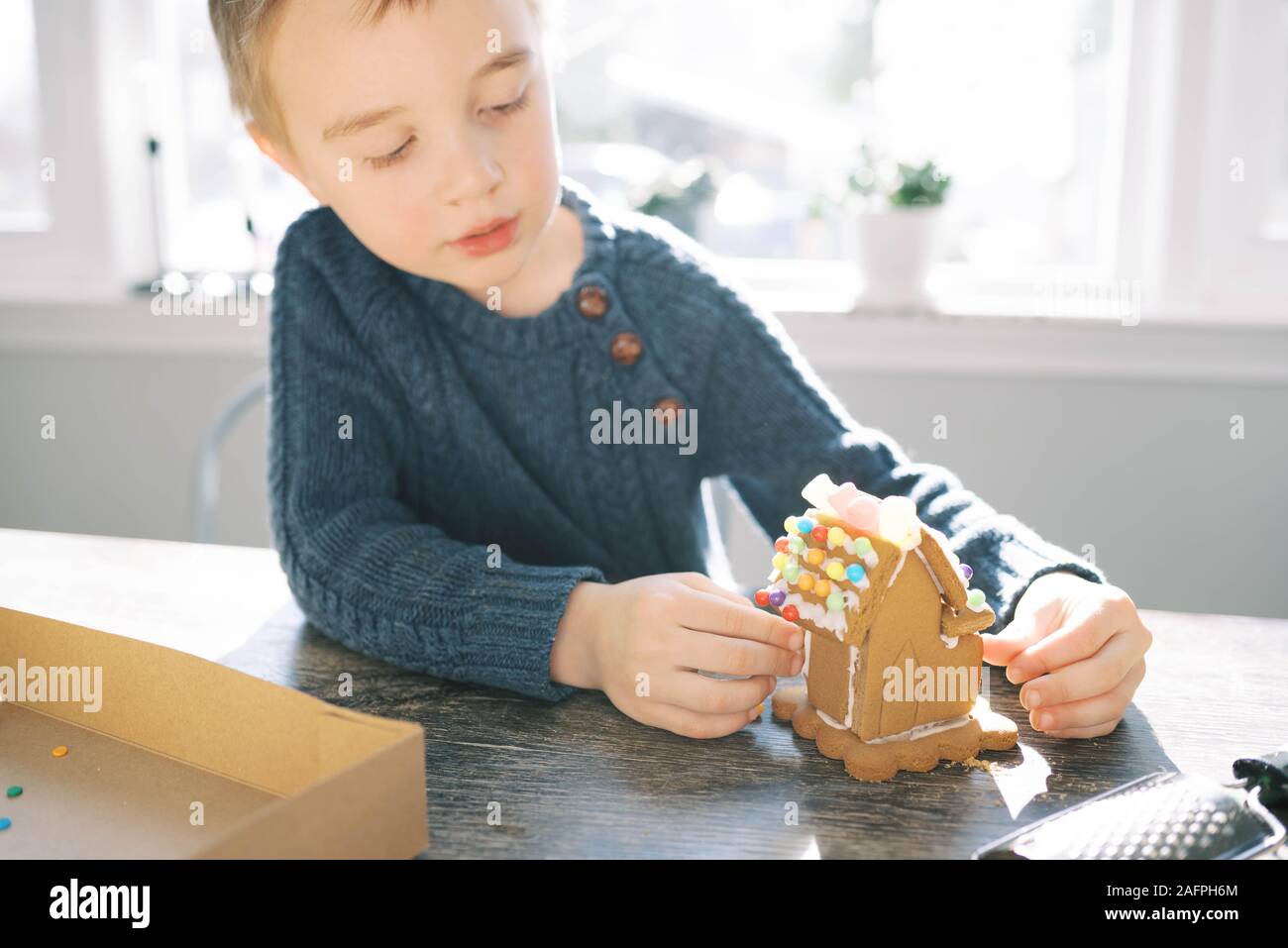 Young girl eating gingerbread man hi-res stock photography and images ...