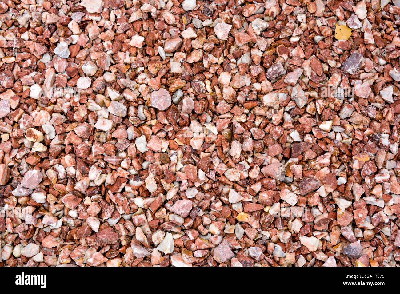 Red and white granite fine gravel. Simple stone background with red ...