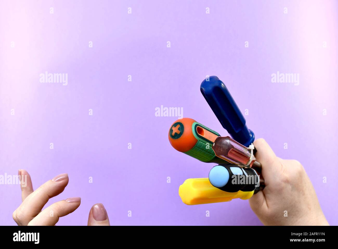 Two hands, one multiple screwdrivers, the other carried a gesture of ...