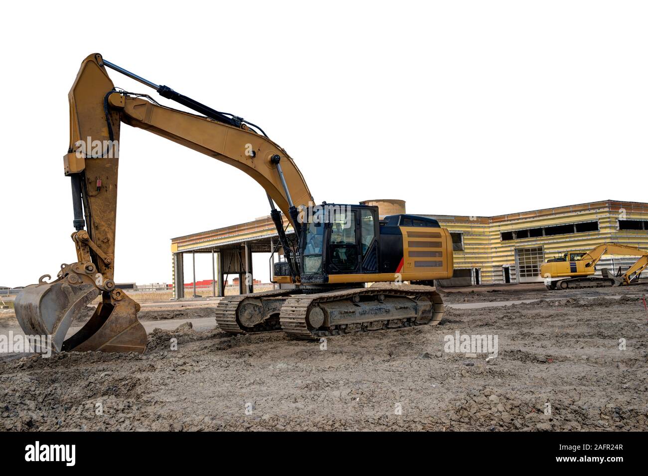 Excavating machinery at the construction site, isolated on white ...