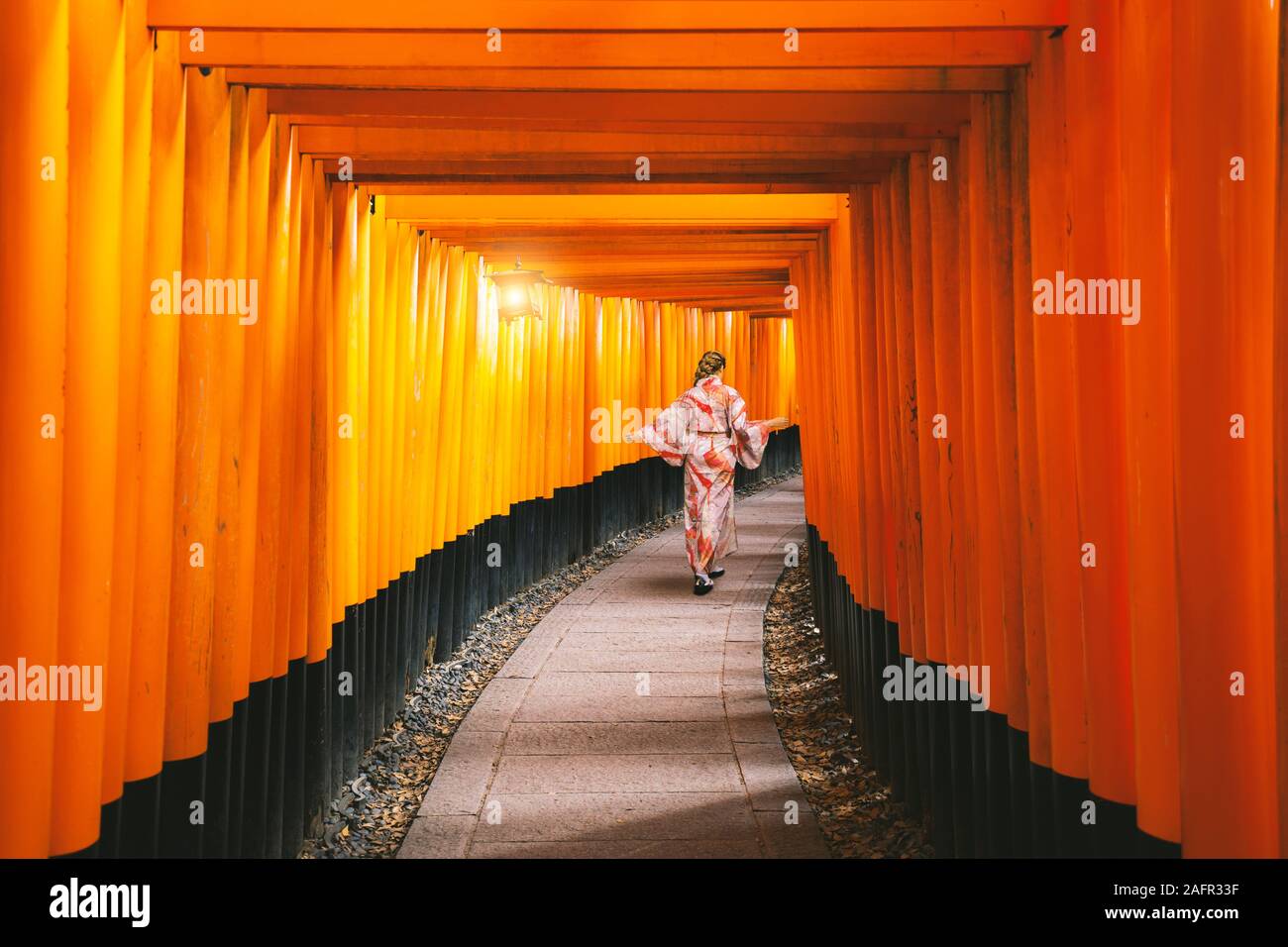 Yong Women in traditional japanese kimonos walking at Fushimi Inari ...